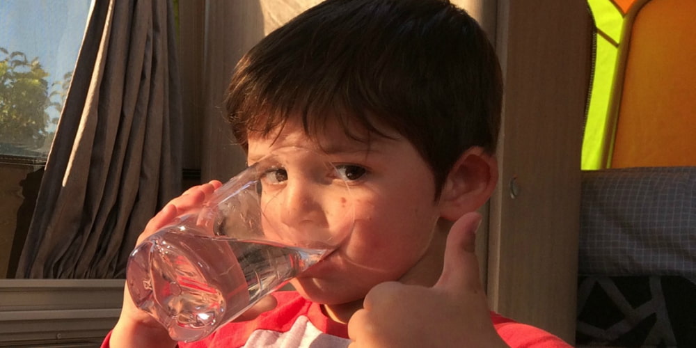WFA – Kid thumbs up while drinking water | Water Filters Australia
